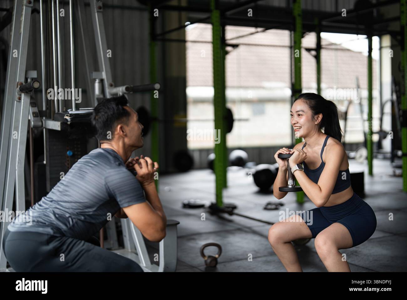Strength Training and Personal Coaching. A trainer guiding a woman ...