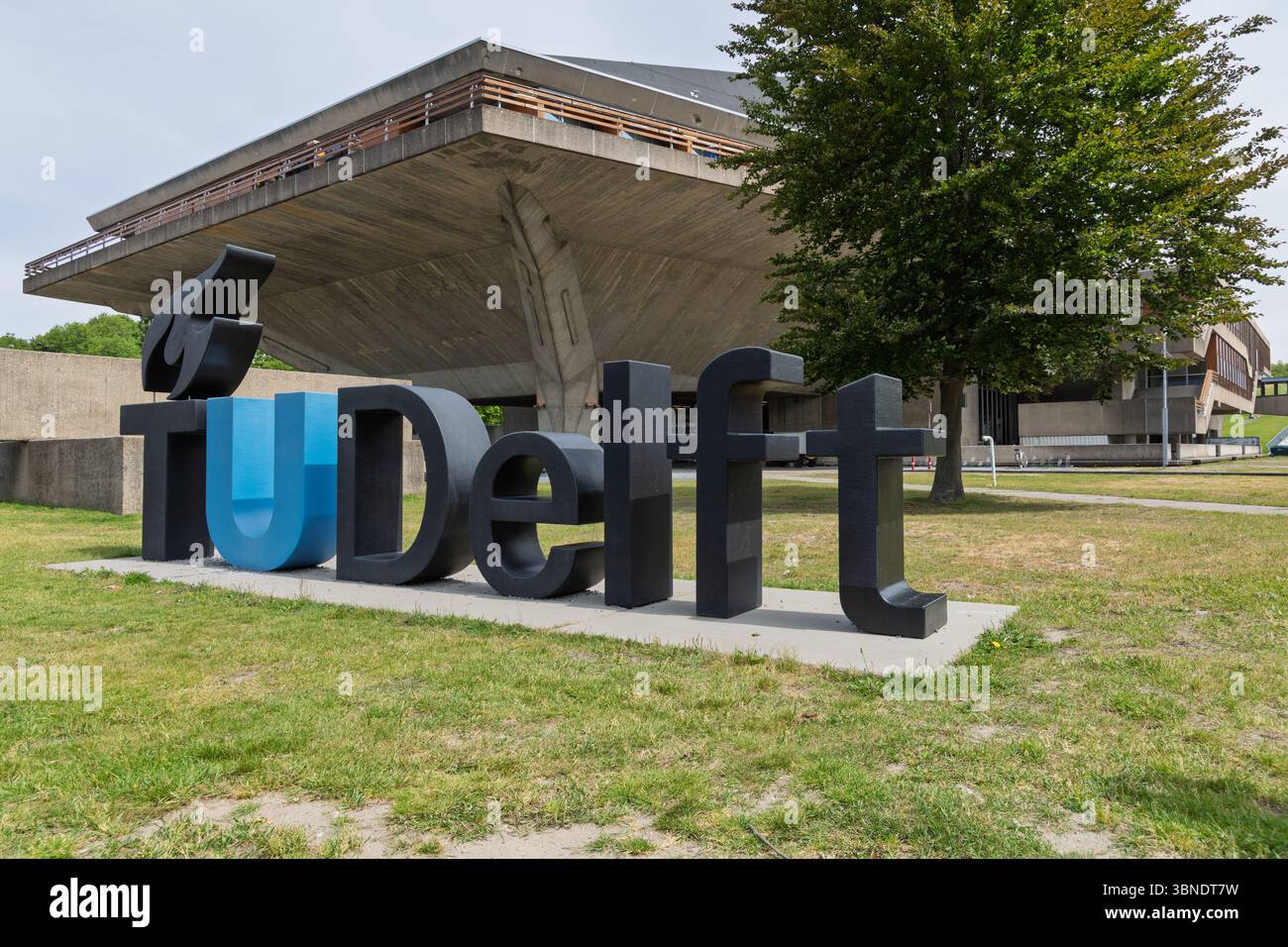Large "TU Delft" letters in a vibrant blue and black, set against a ...