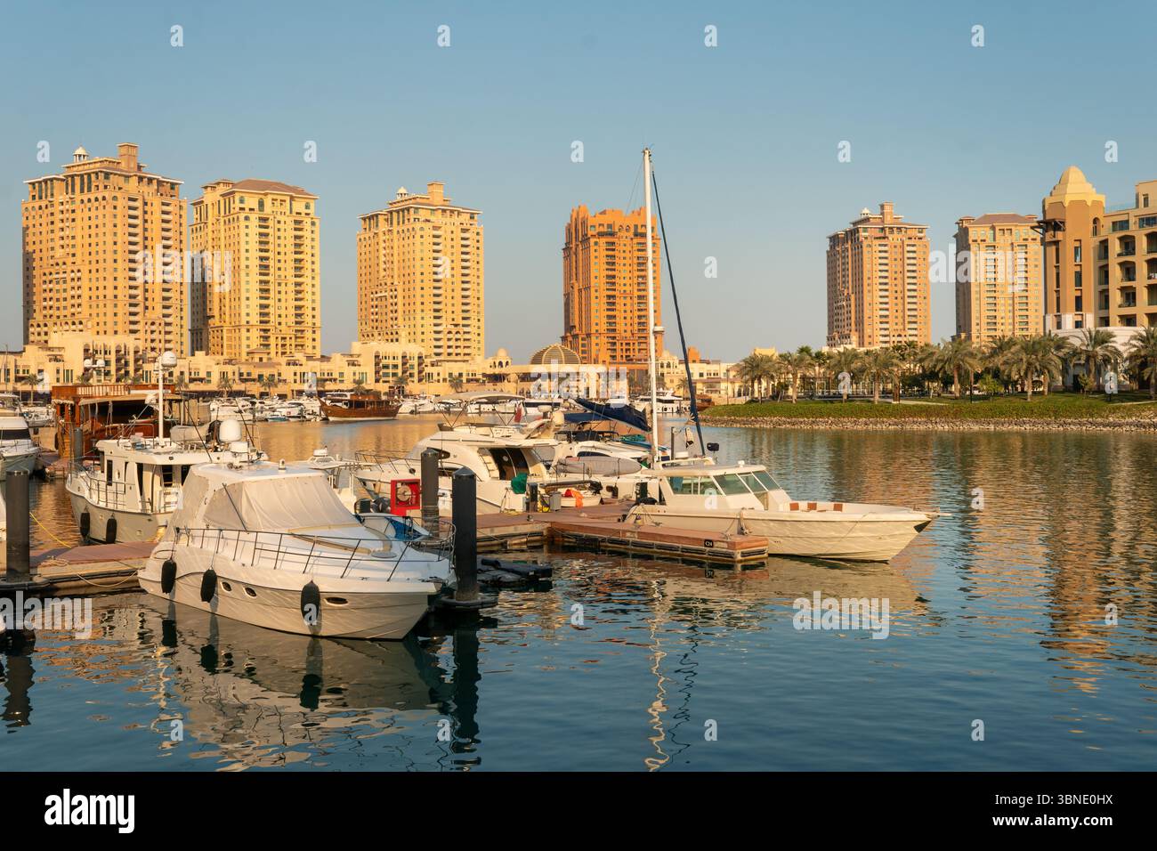 The marina waterfront walkway at the Pearl in Doha, Qatar, with shops ...