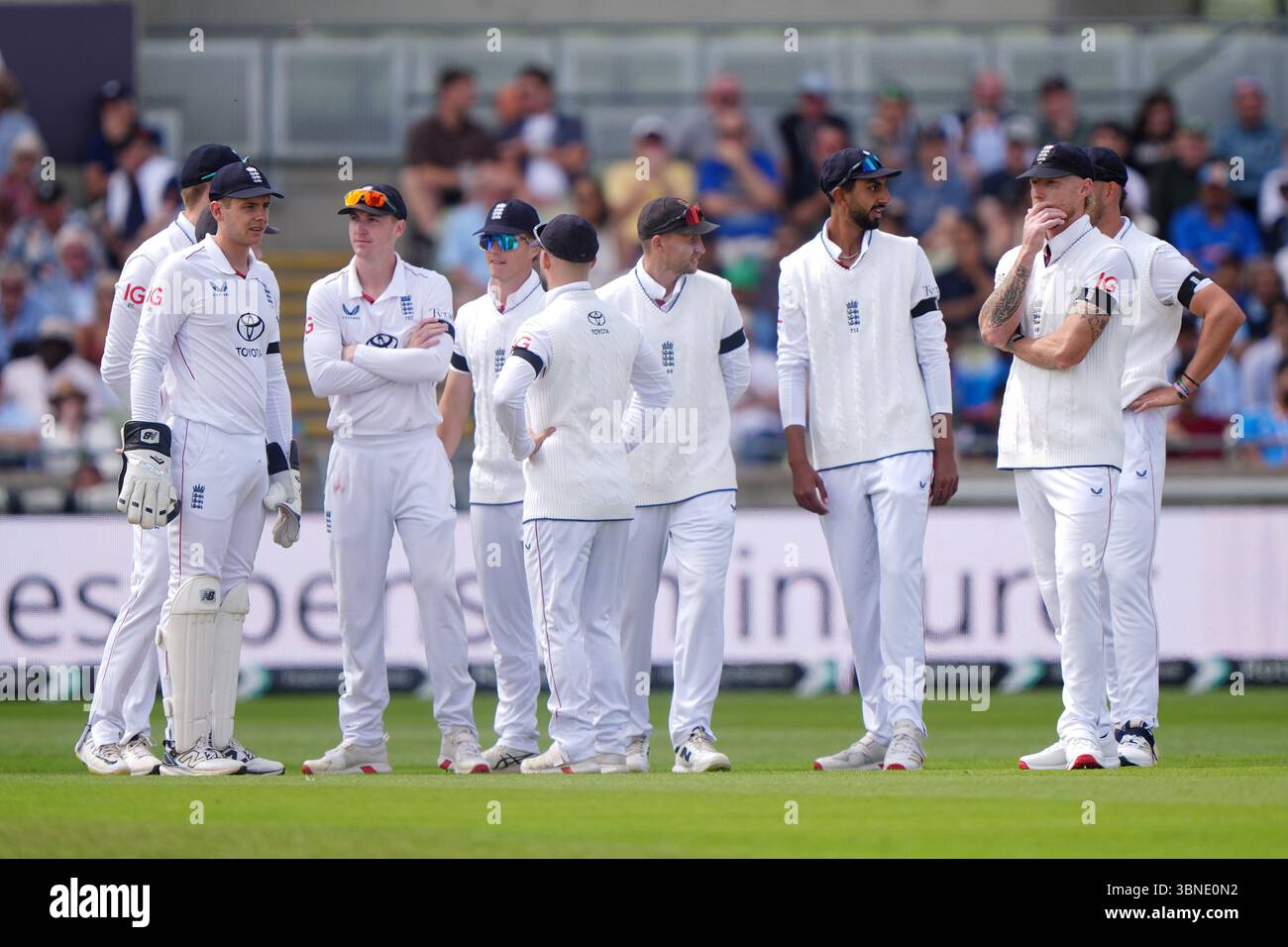 England's Ben Stokes and team-mates wait during a review on day one of ...