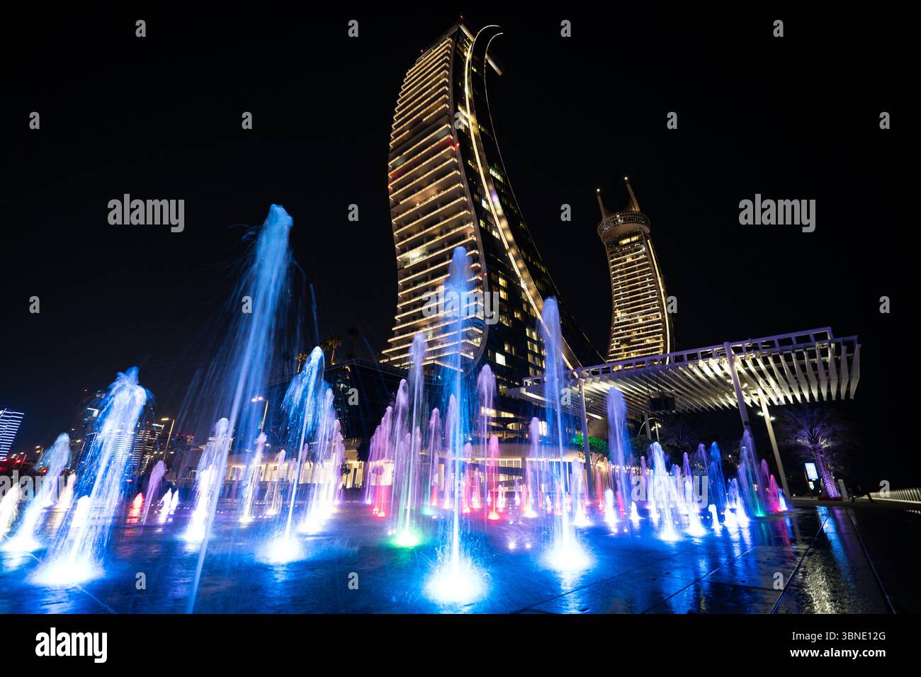 Doha, Qatar. Beautiful high-rise skyscraper with modern style on a blue ...