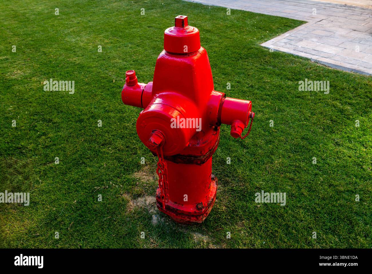 A bright red fire hydrant standing on a sidewalk, symbolizing safety ...