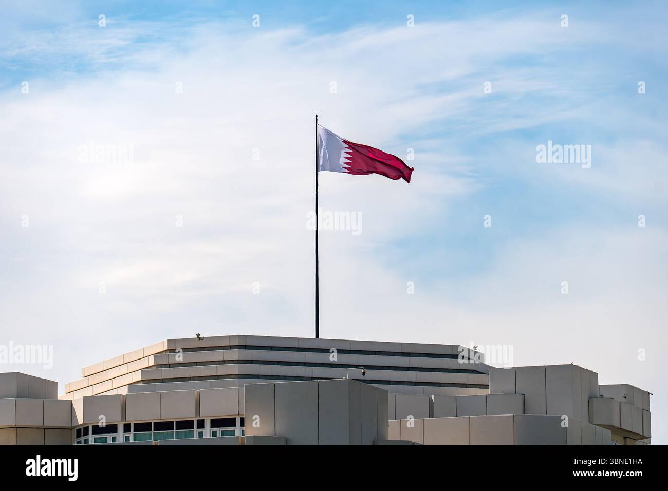 Emiri Diwan Palace, the center of government, in Doha, Qatar. Flag on ...