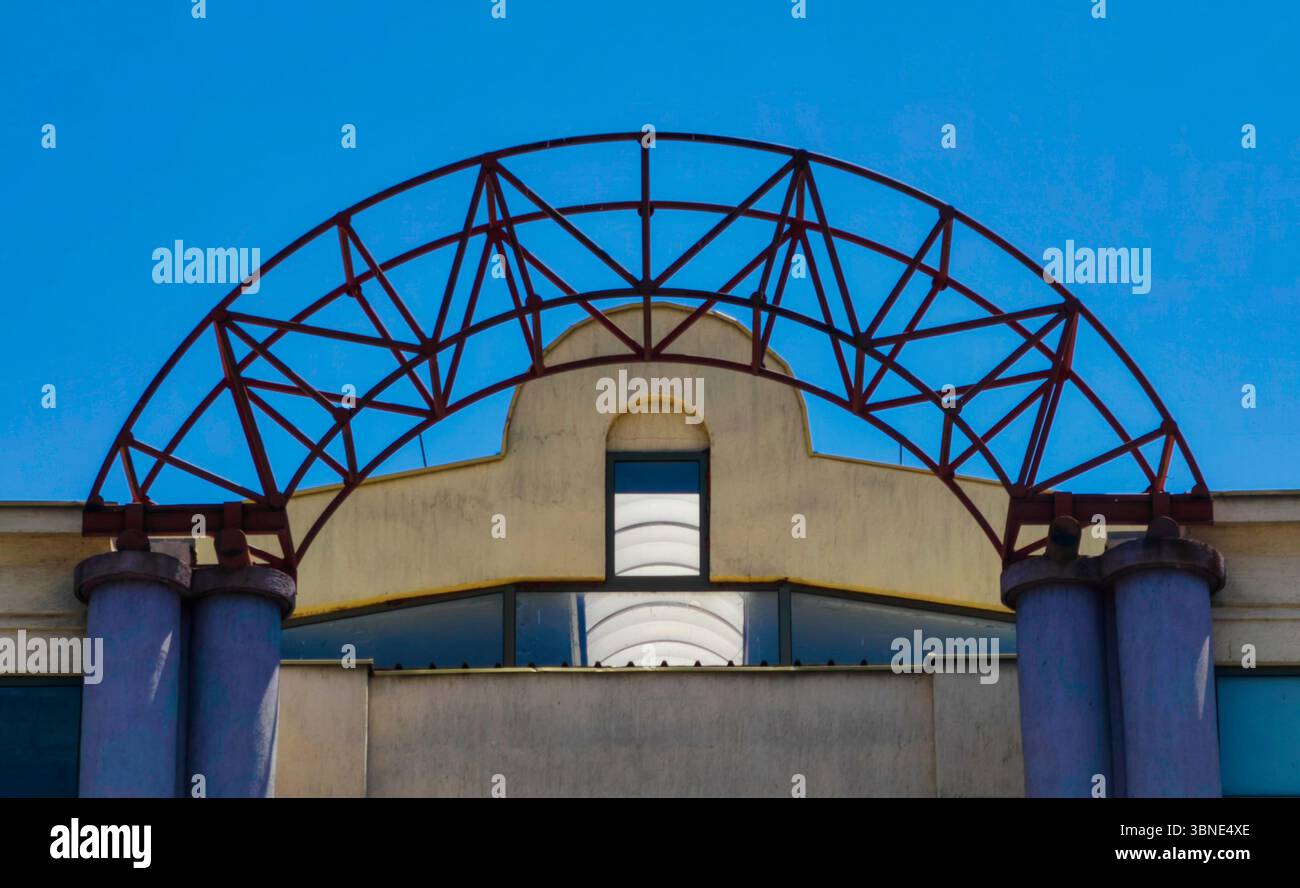 Metal Arch Frame Construction Framing Sunlit Window at Top of Building ...