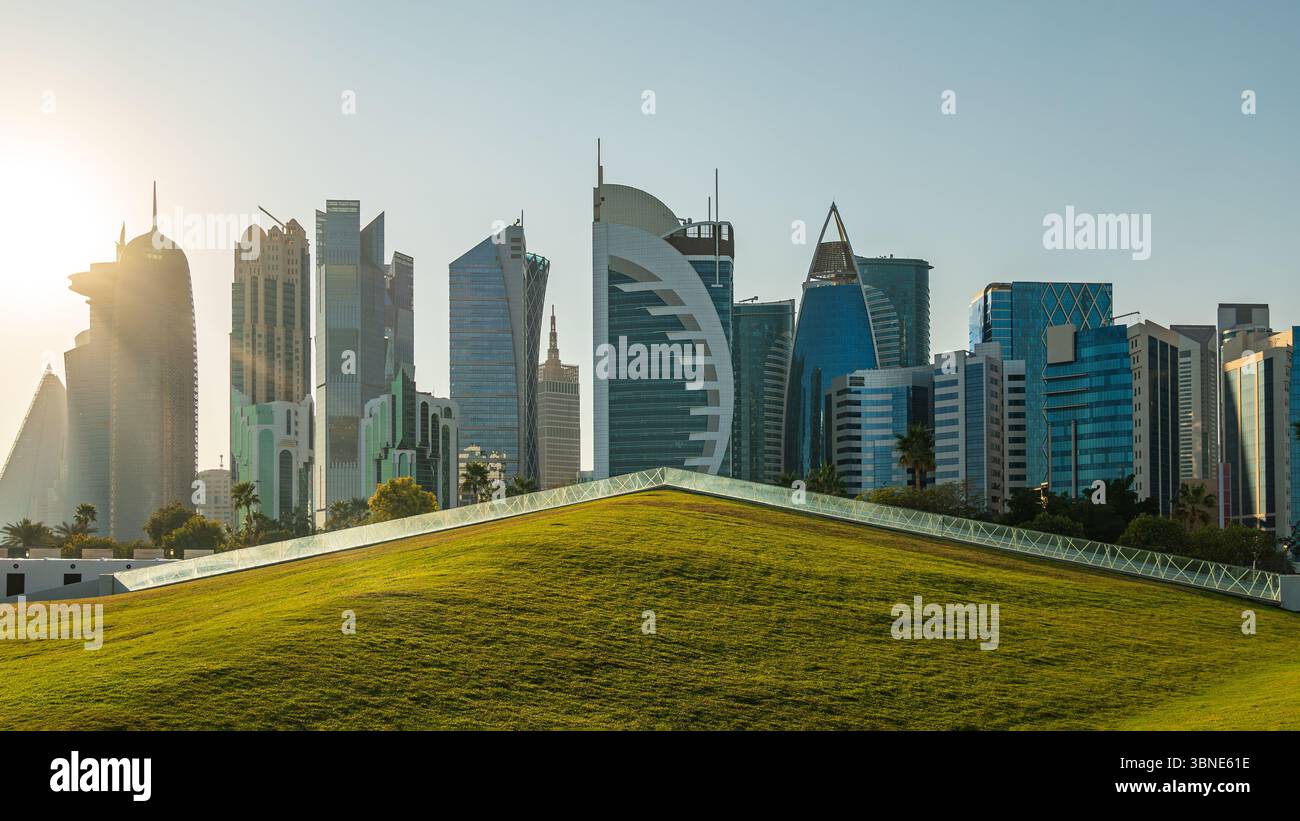 Tall modern skyscrapers tower over the central park in Doha Qatar ...