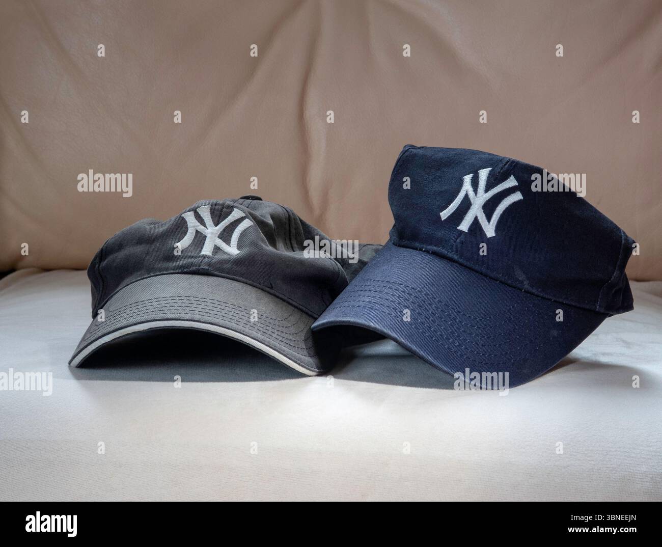 Still life of a faded and well loved Yankees baseball cap alongside a ...