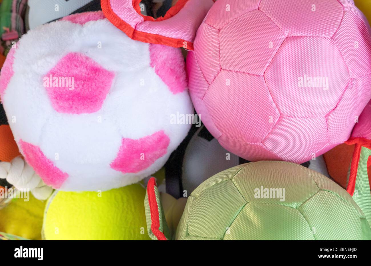 A vibrant and colorful collection of plush sports balls that are ...