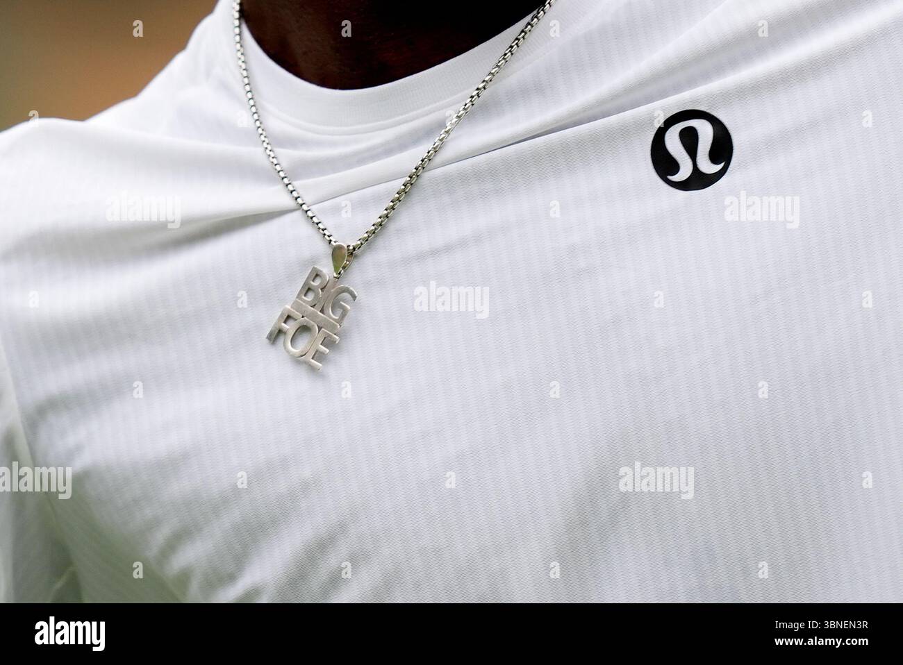 The neck chain of Frances Tiafoe during the match against Cameron ...