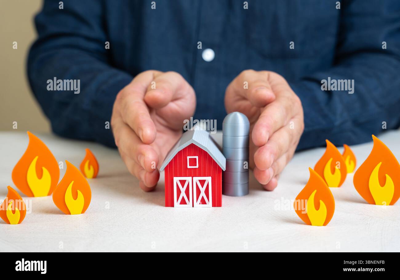 A man protects a farm from fire. Safety in difficult climate conditions ...