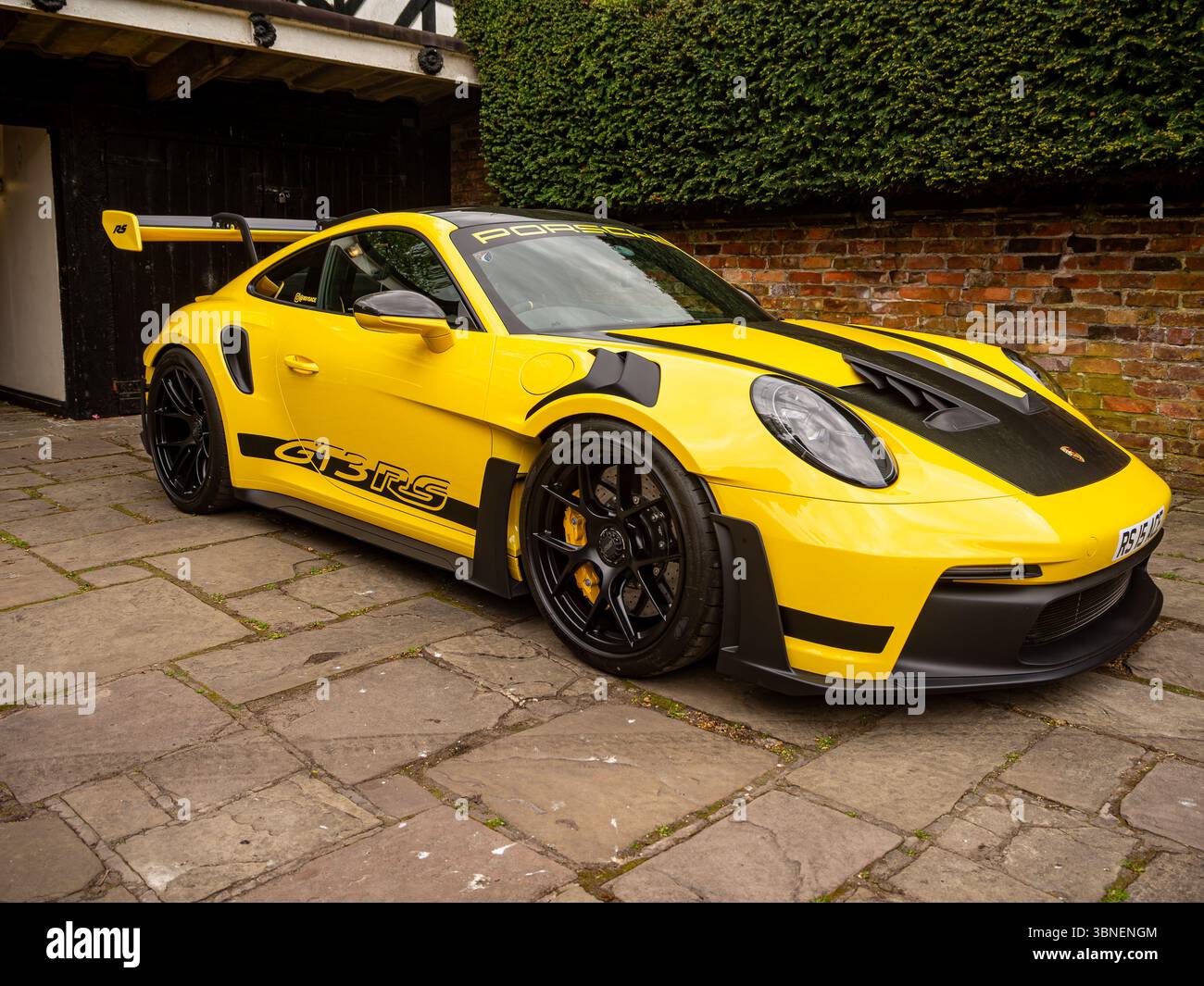 Porsche GT3RS in Yellow and Black parked on york stone paving outside a ...