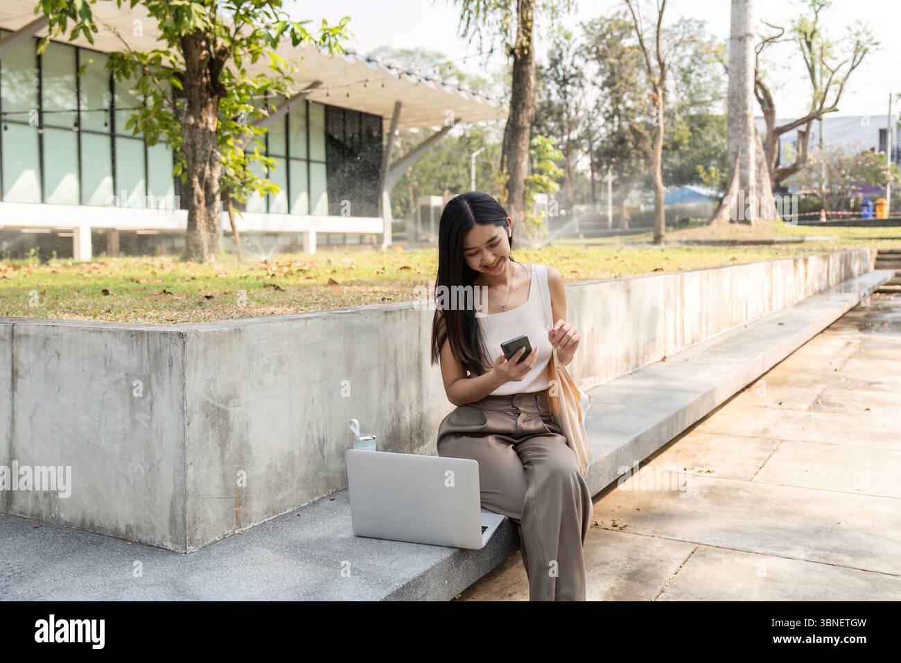 Young woman outdoors happily using hi-res stock photography and images ...