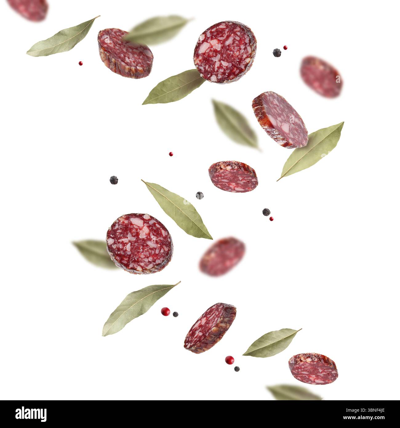 Smoked sausage slices and aromatic spices falling on white background ...