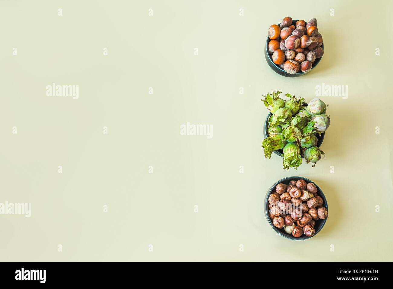 Hazelnuts at various stages of processing placed in ceramic bowls ...