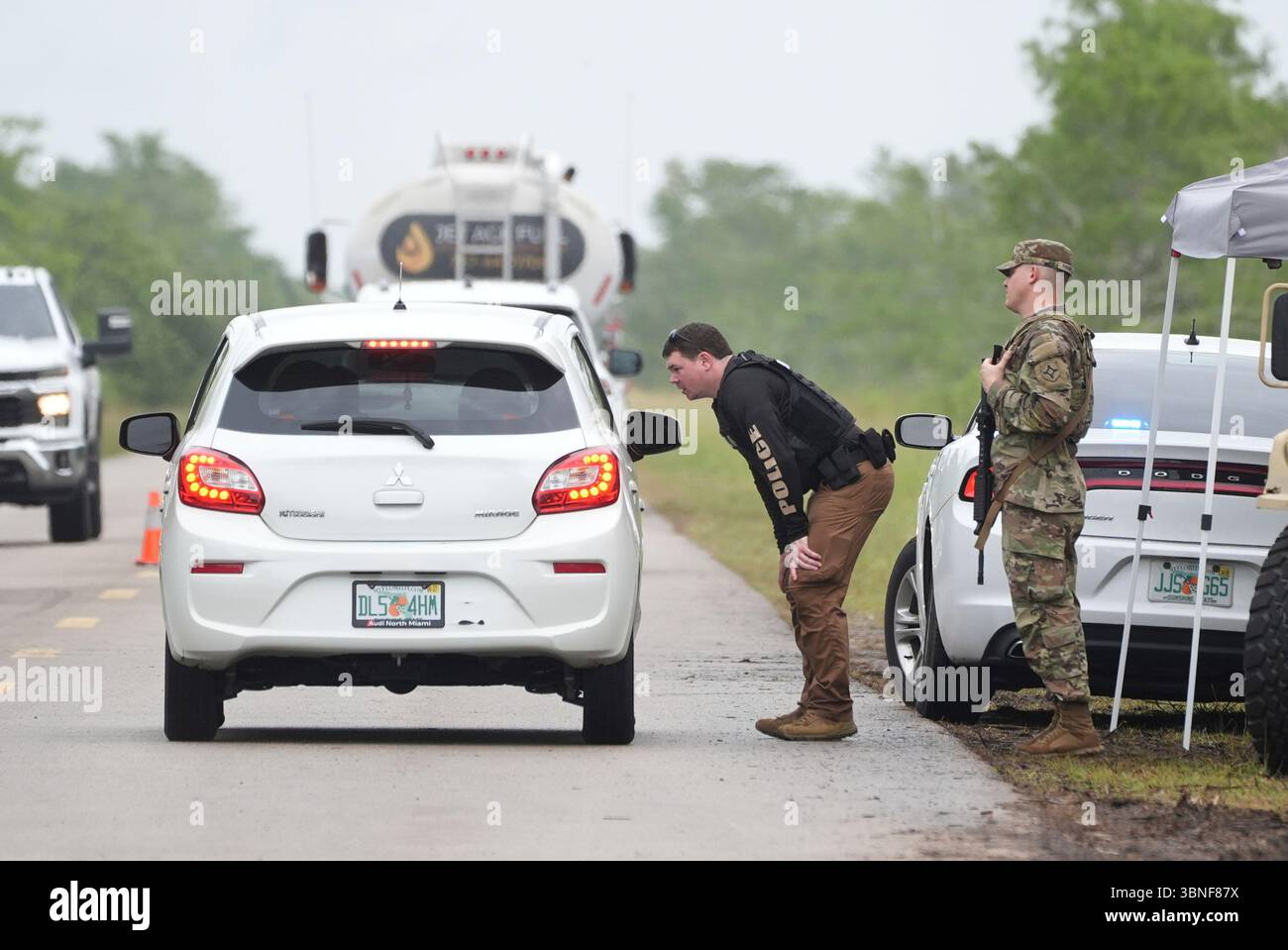 Police check cars arriving at the "Alligator Alcatraz," a new migrant ...