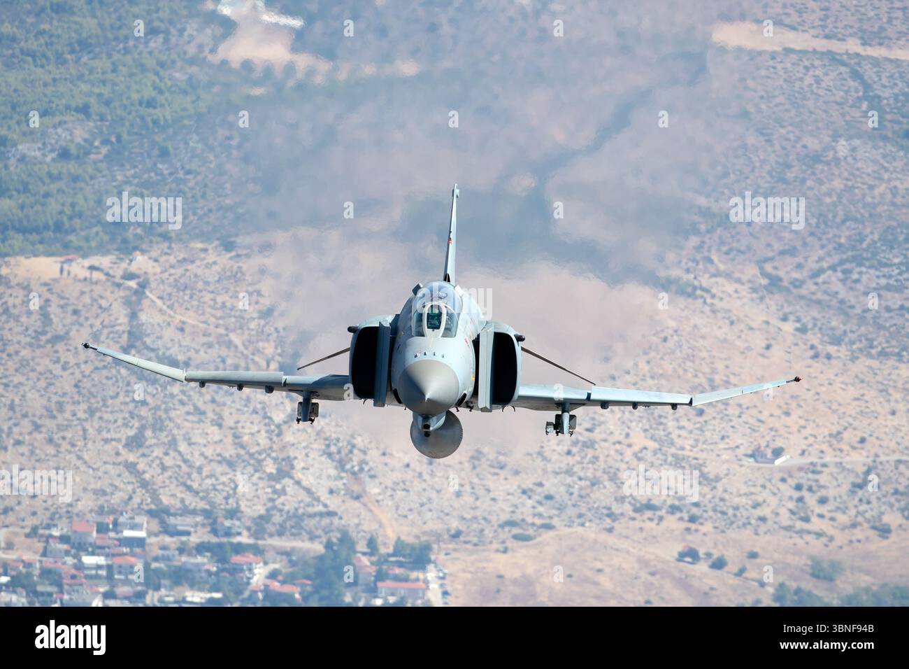 Hellenic Air Force F‑4E AUP Phantom II rolls out of a high‑G turn above ...
