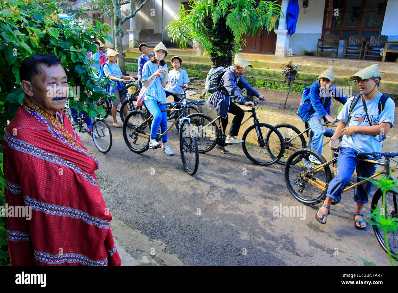 Cyclists observe villagers covering their bodies with sarongs to ward ...