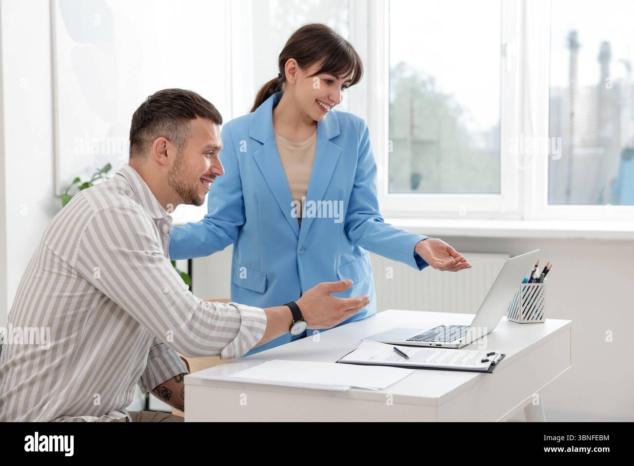 Consultant working with client at table in office. Business meeting ...