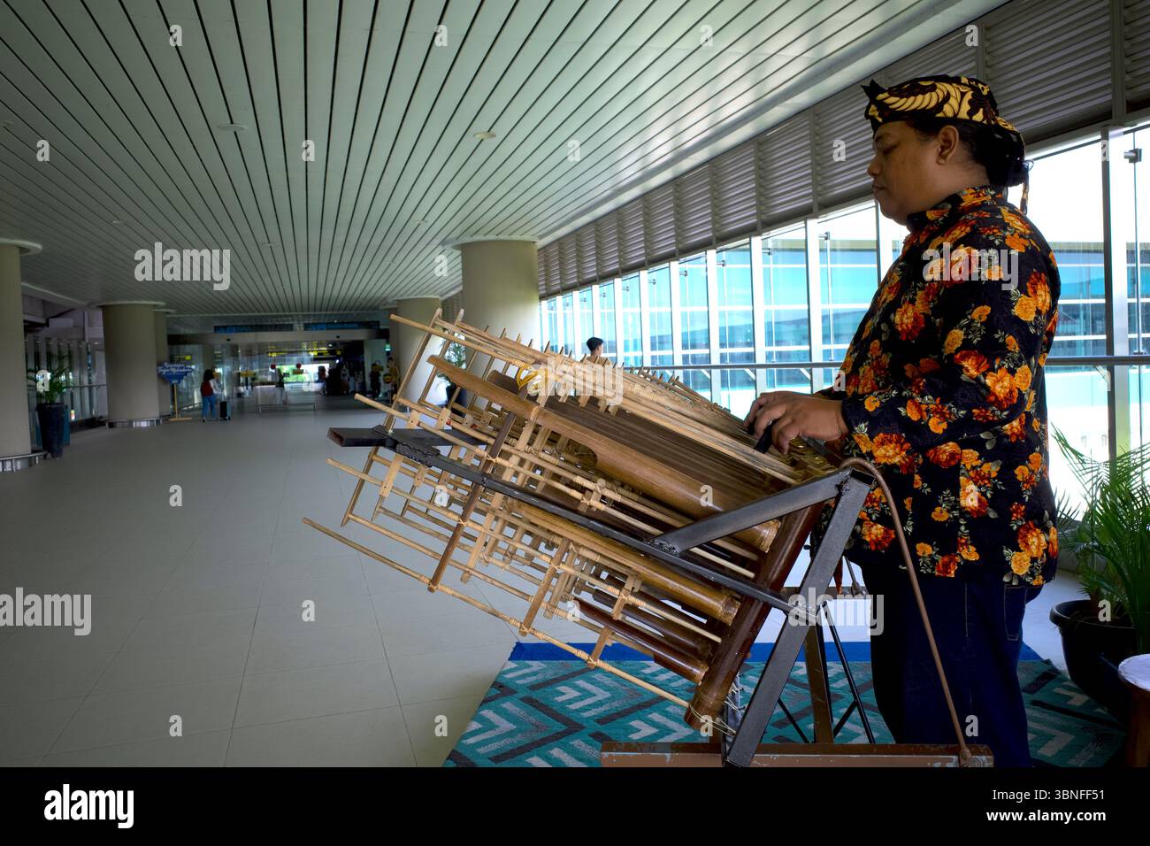 Yogyakarta, Indonesia - December 21, 2024: A musician plays angklung, a ...