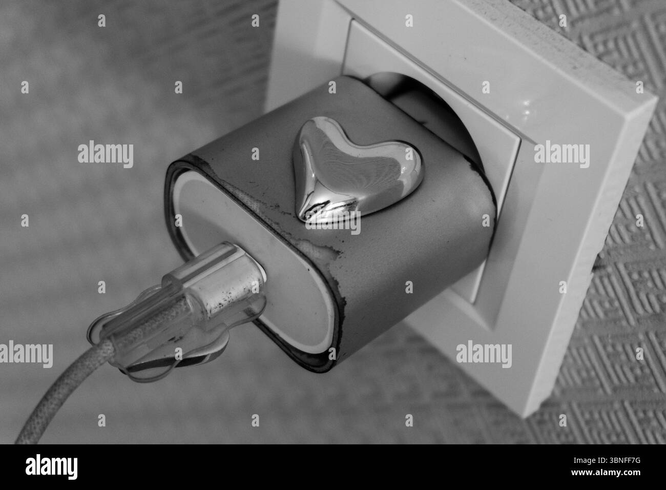 Love adapter plugged into the electricity socket Stock Photo - Alamy
