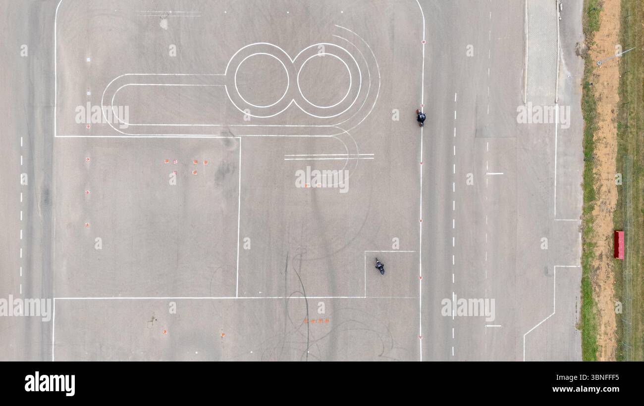 Aerial view of a motorcycle training course with marked lanes and two ...