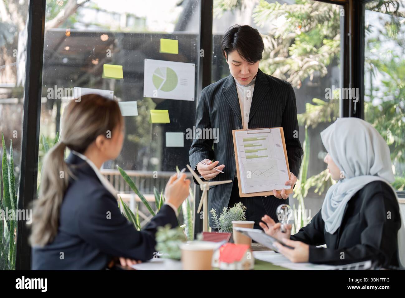 Innovation and Strategy. A team presenting eco-friendly initiatives in ...