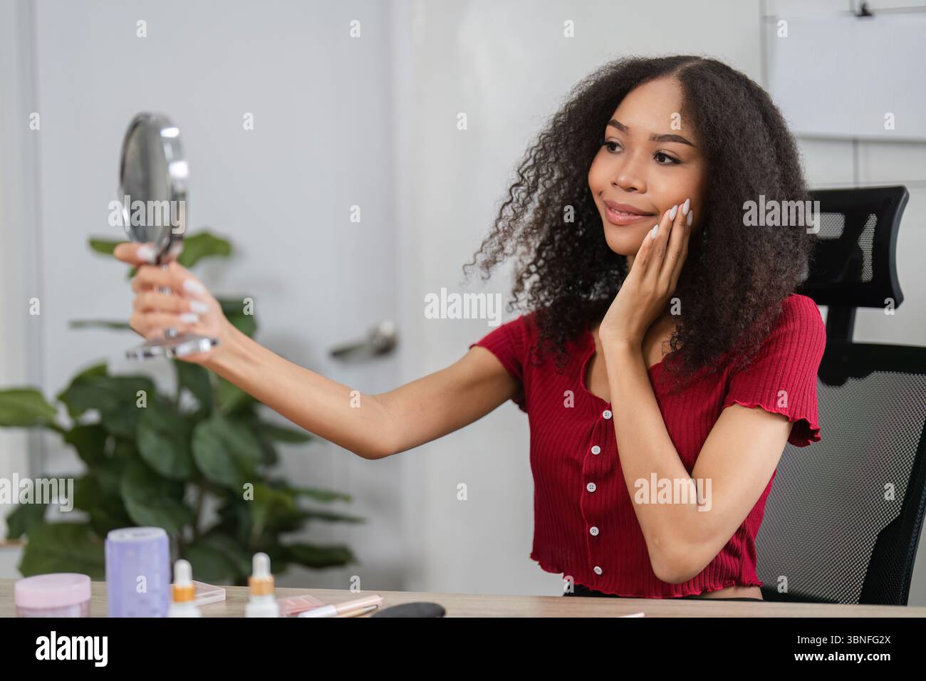 Reflecting Beauty and Self-Love. A woman admiring her appearance in the ...