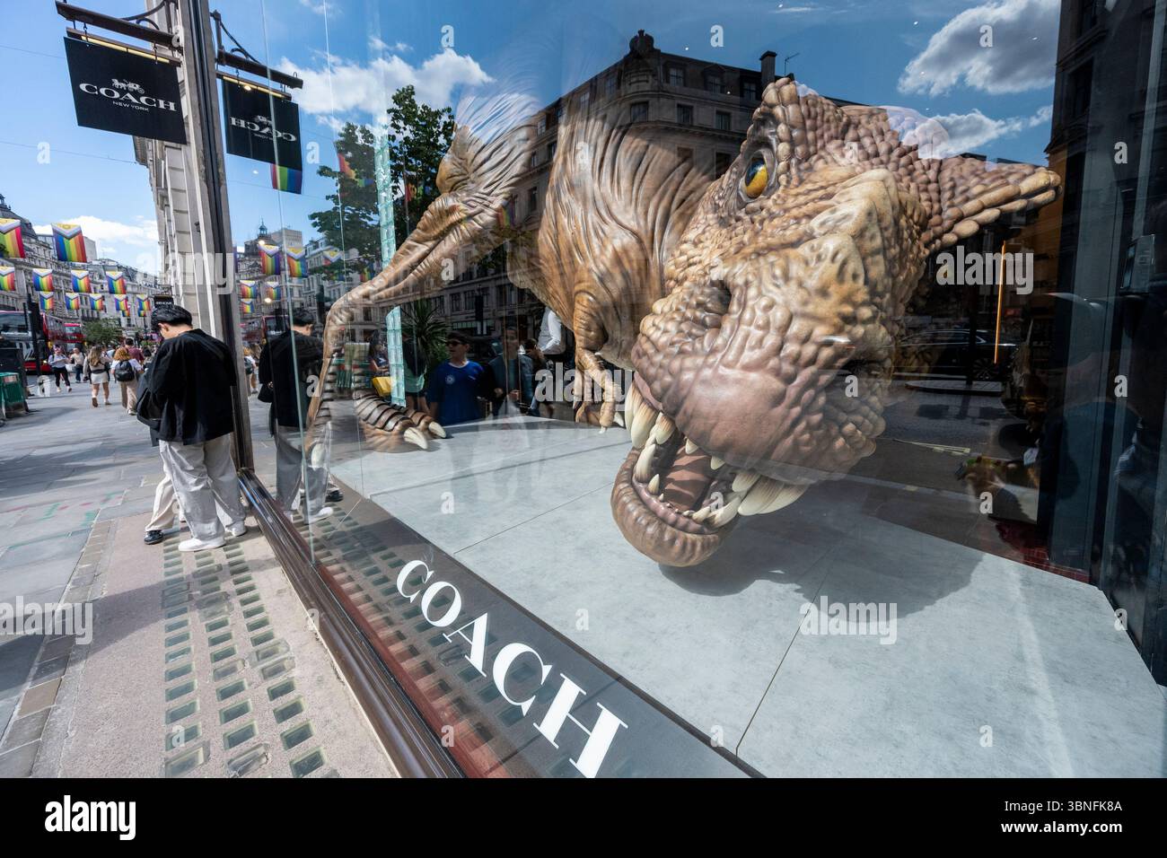 London, UK. 2 July 2025. People pass the T Rex dinosaur in the window ...