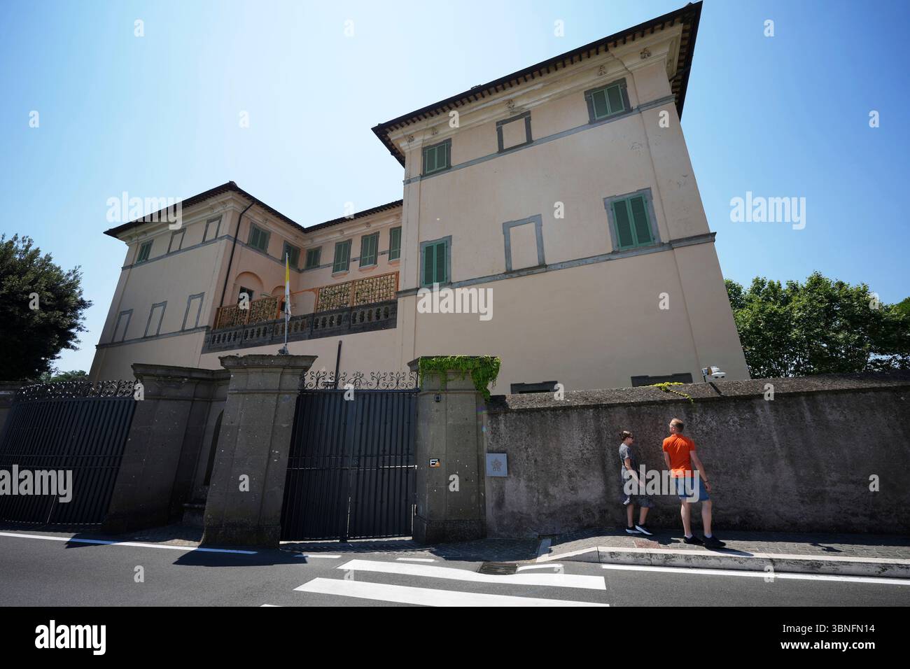 People walk past the Villa Barberini Palace in the town of Castel ...
