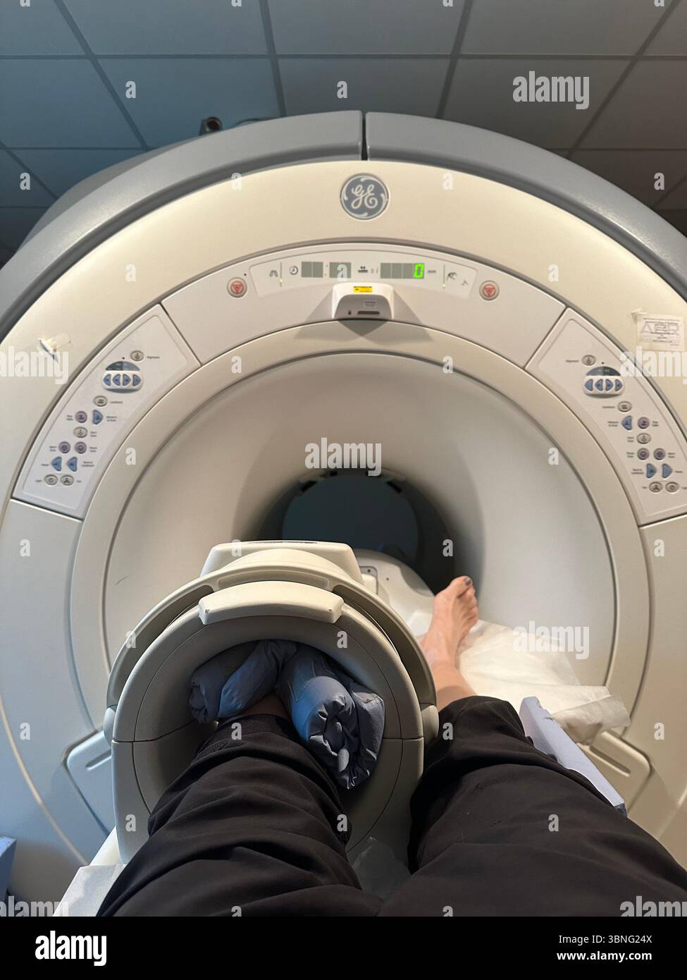 In a diagnostic center, a patient is ready to do magnetic resonance ...