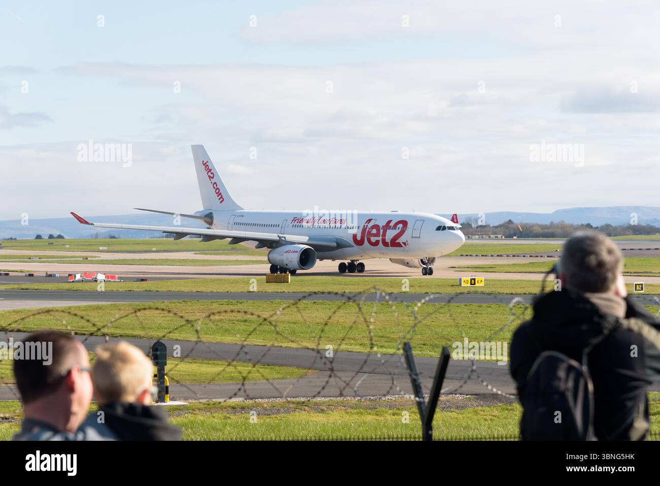 Plane spotters watching aircraft at Manchester international airport ...
