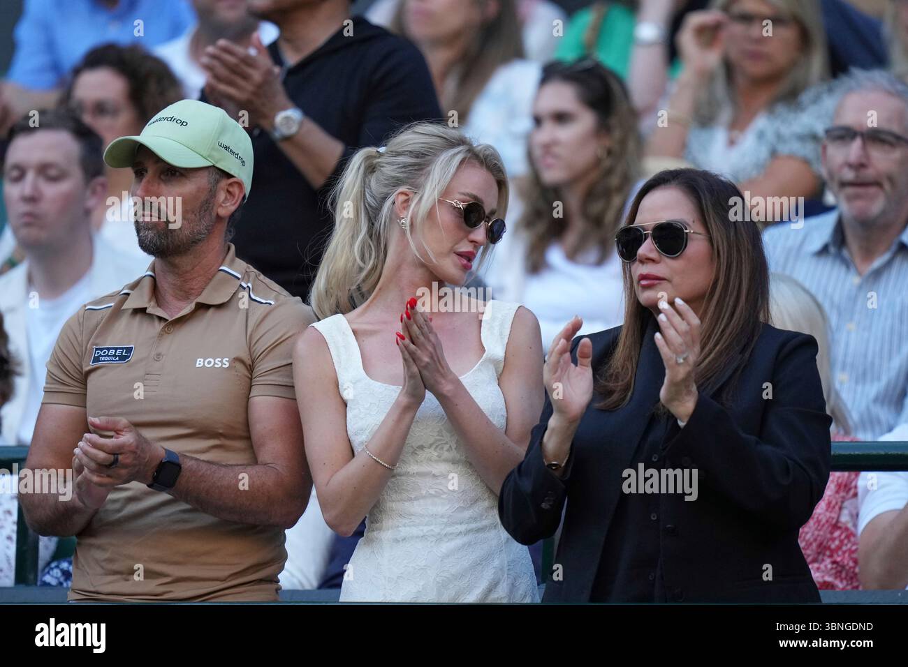 Taylor Fritz's girlfriend, Morgan Riddle, center, watches as he plays ...