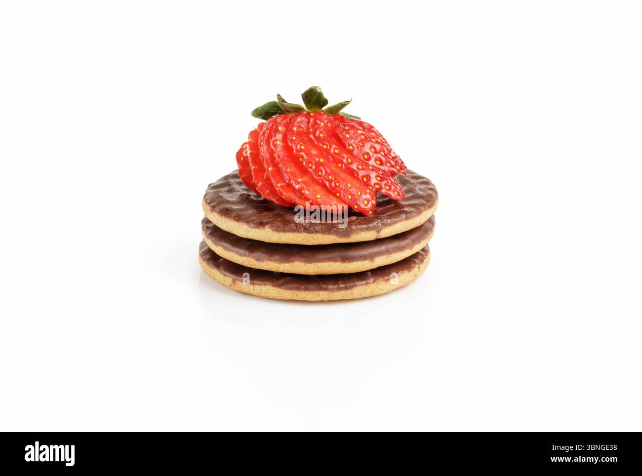 Three chocolate biscuits topped with sliced strawberry food cut out ...