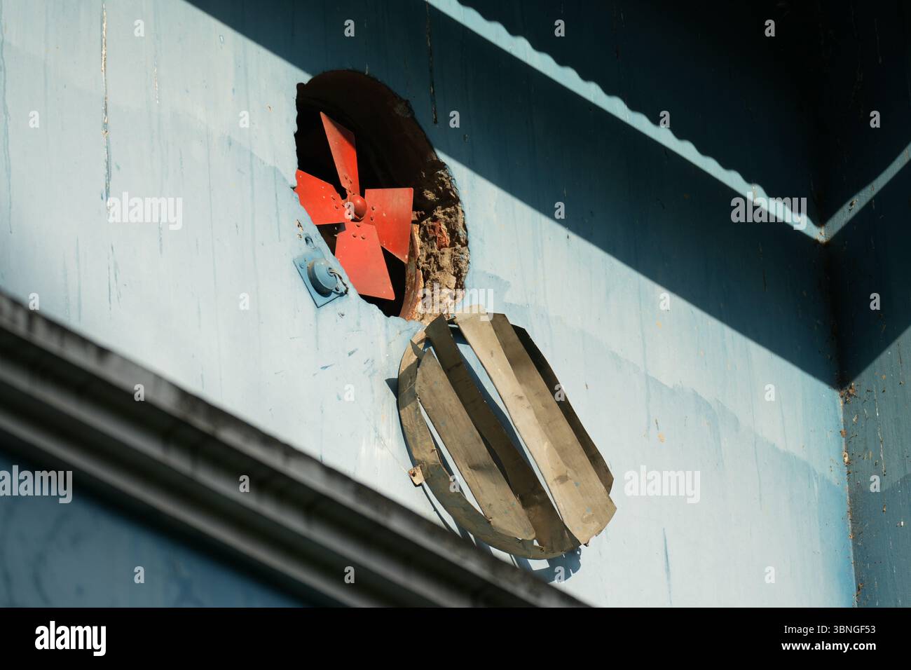 Damaged wall with exposed ventilation fan Stock Photo - Alamy