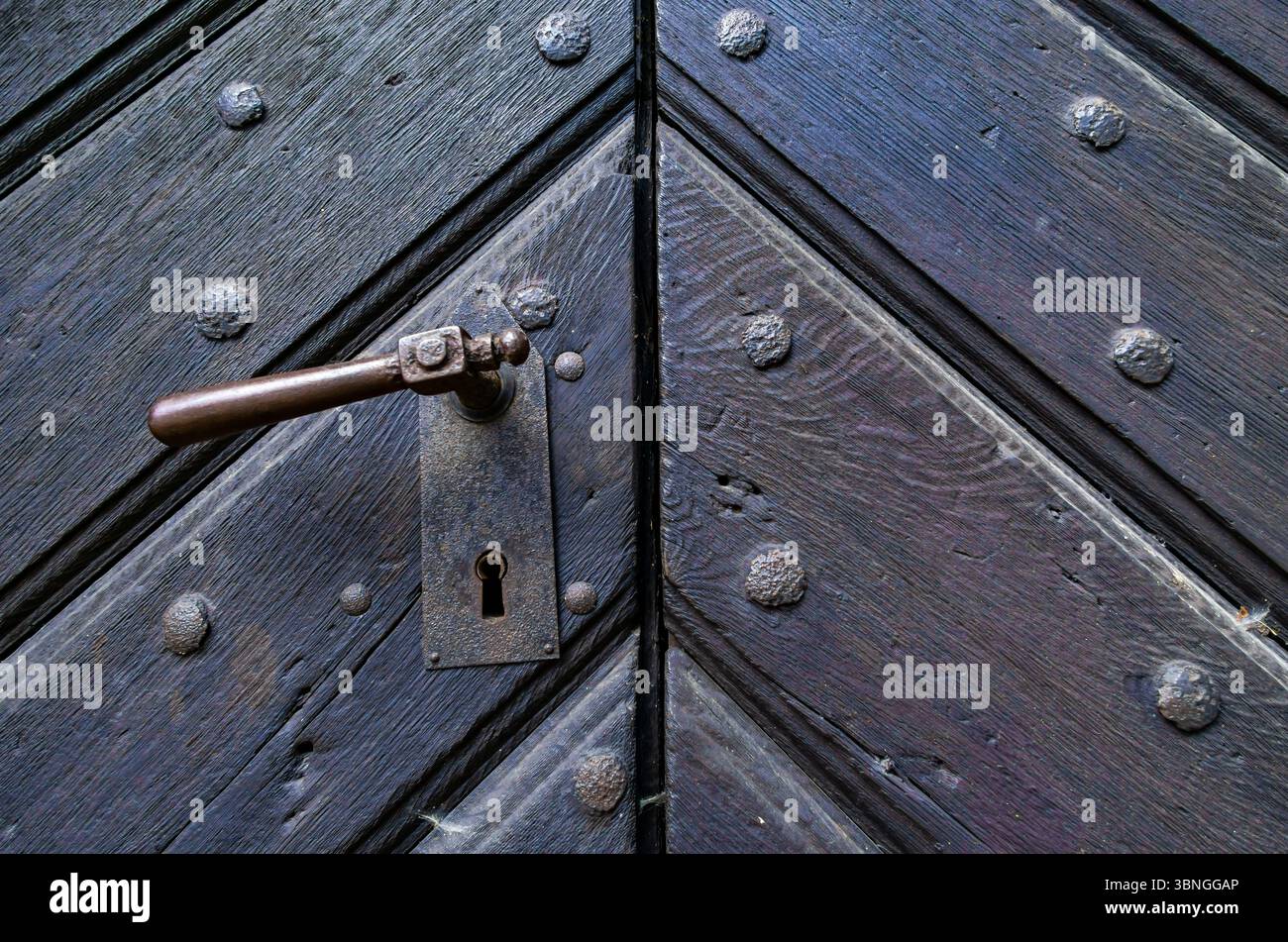 Detailed view of an old wooden church door with iron handle, keyhole ...