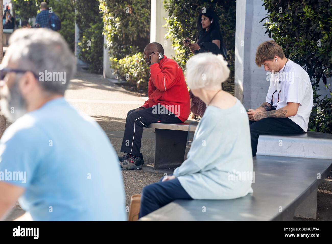 Group people sitting on benches hi-res stock photography and images - Alamy