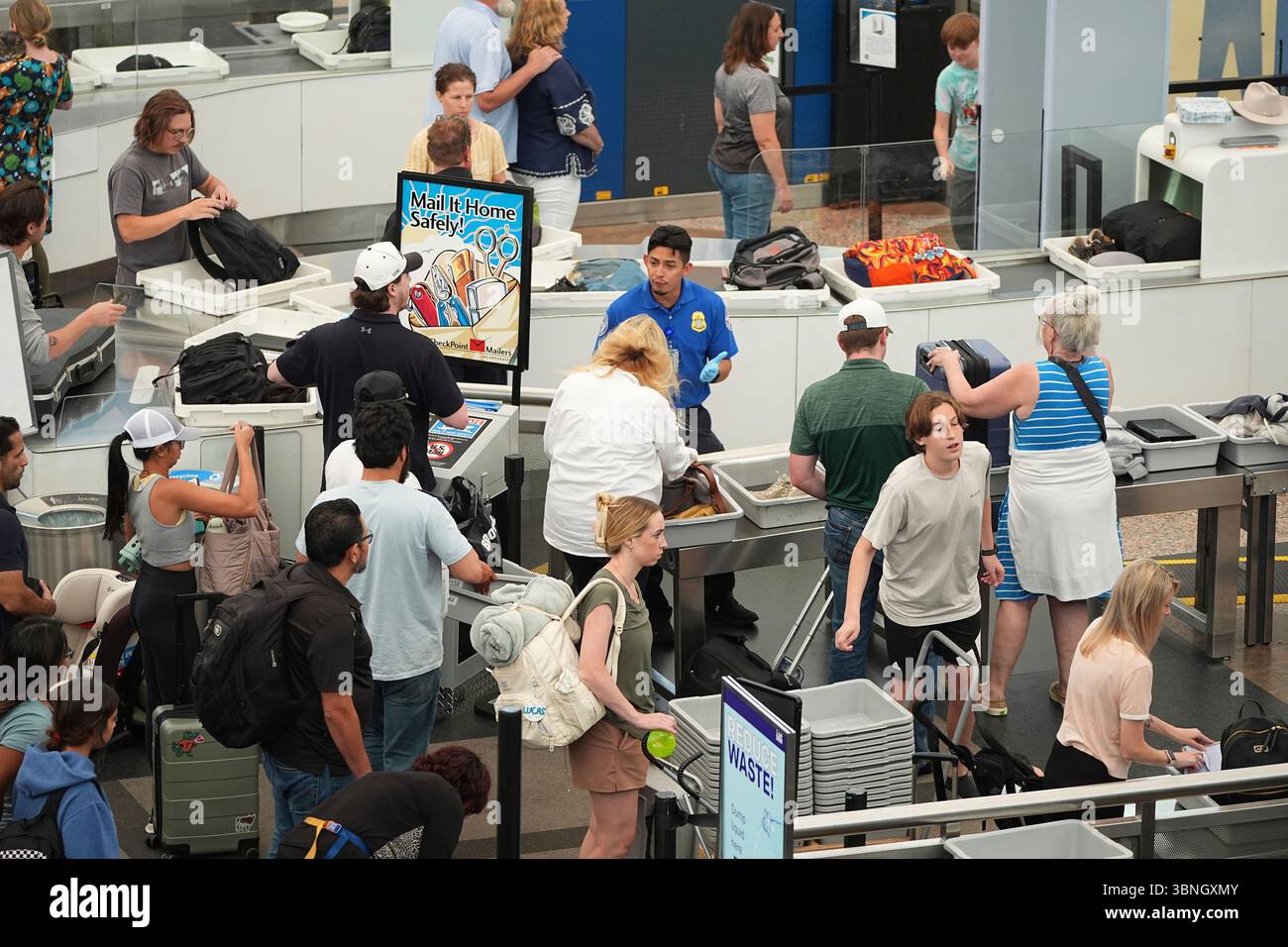 Travelers queue up to pass through the south security checkpoint in ...