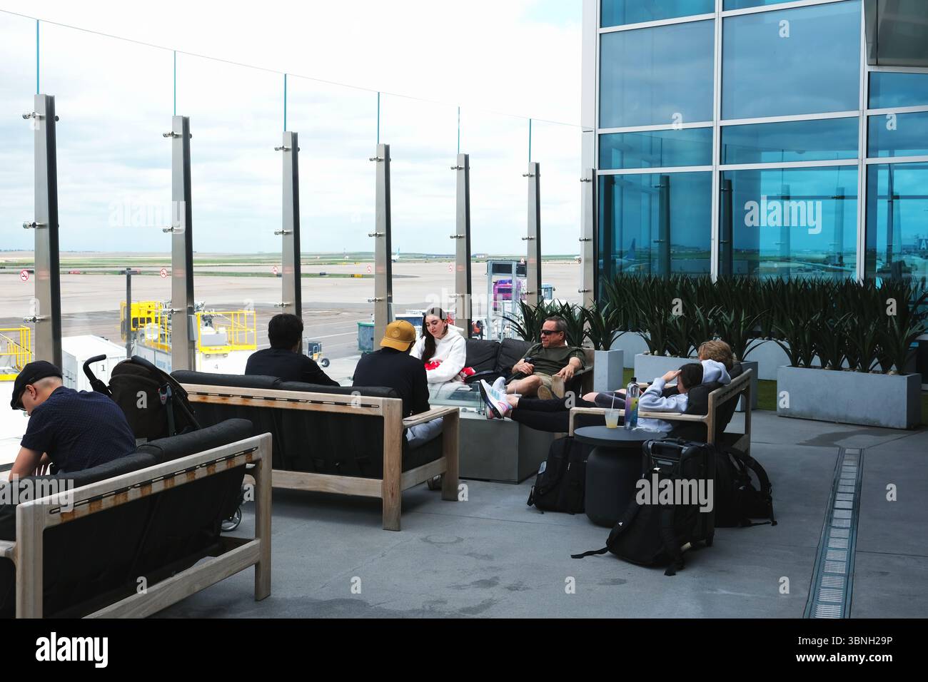Airport lounge with people relaxing and waiting Stock Photo - Alamy
