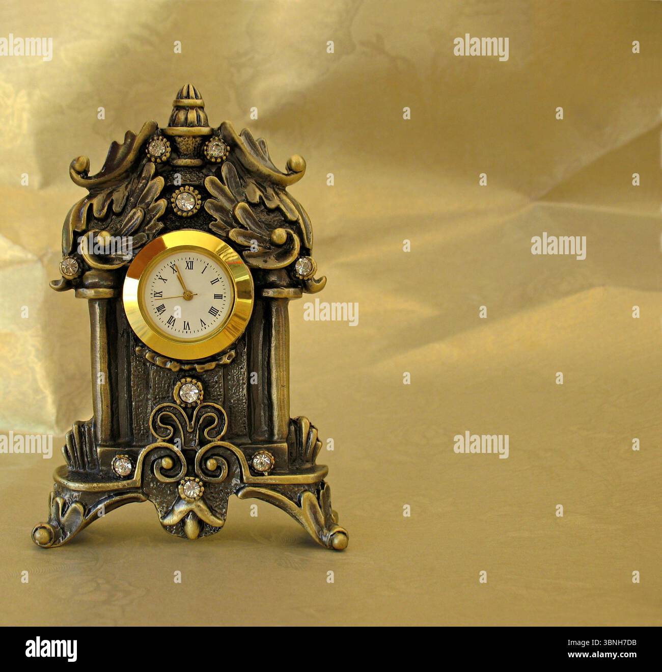 A vintage clock shot on a golden background Stock Photo - Alamy