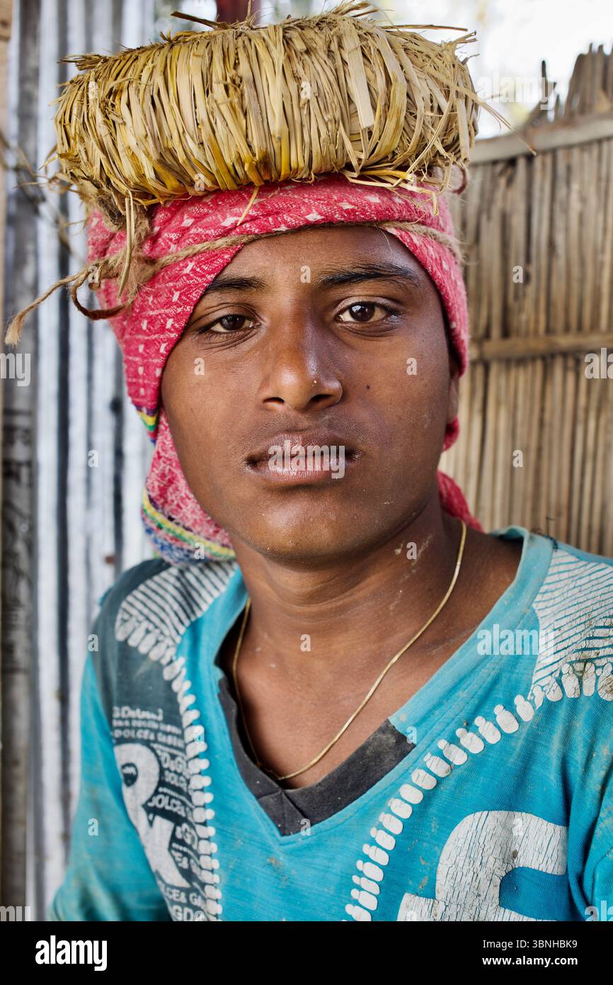 Portrait of a young construction worker involved in the Brahmaputra River revetment project near ...