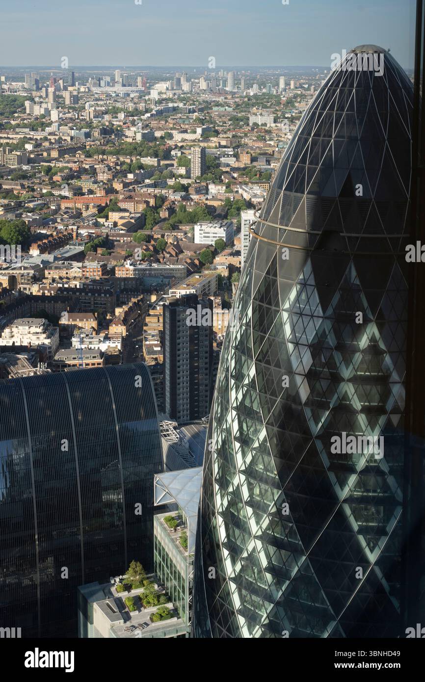 A high-angle view of London, UK, featuring the iconic "Gherkin" (30 St ...
