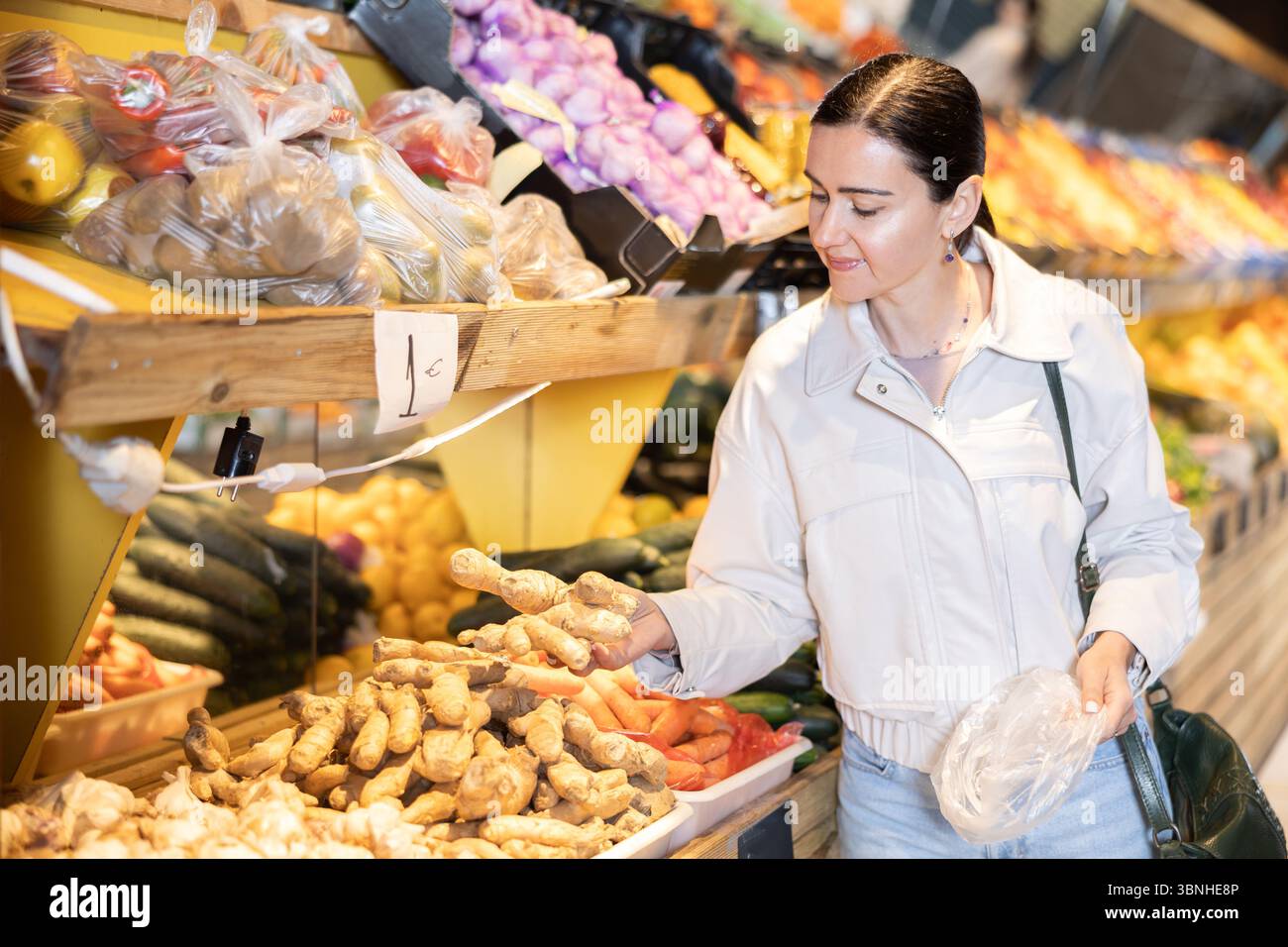 Female shopper selects ginger root in supermarket Stock Photo - Alamy