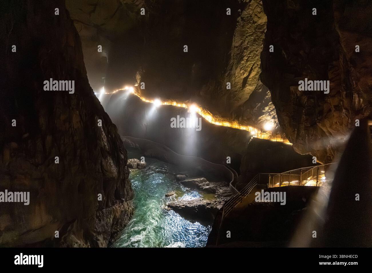 Scenic view of an illuminated path tracing its way through a cave ...