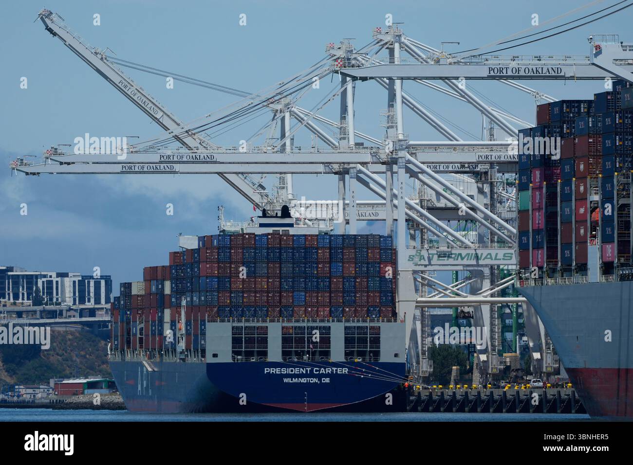 Container ships and cranes at the Port Of Oakland are seen from Alameda ...