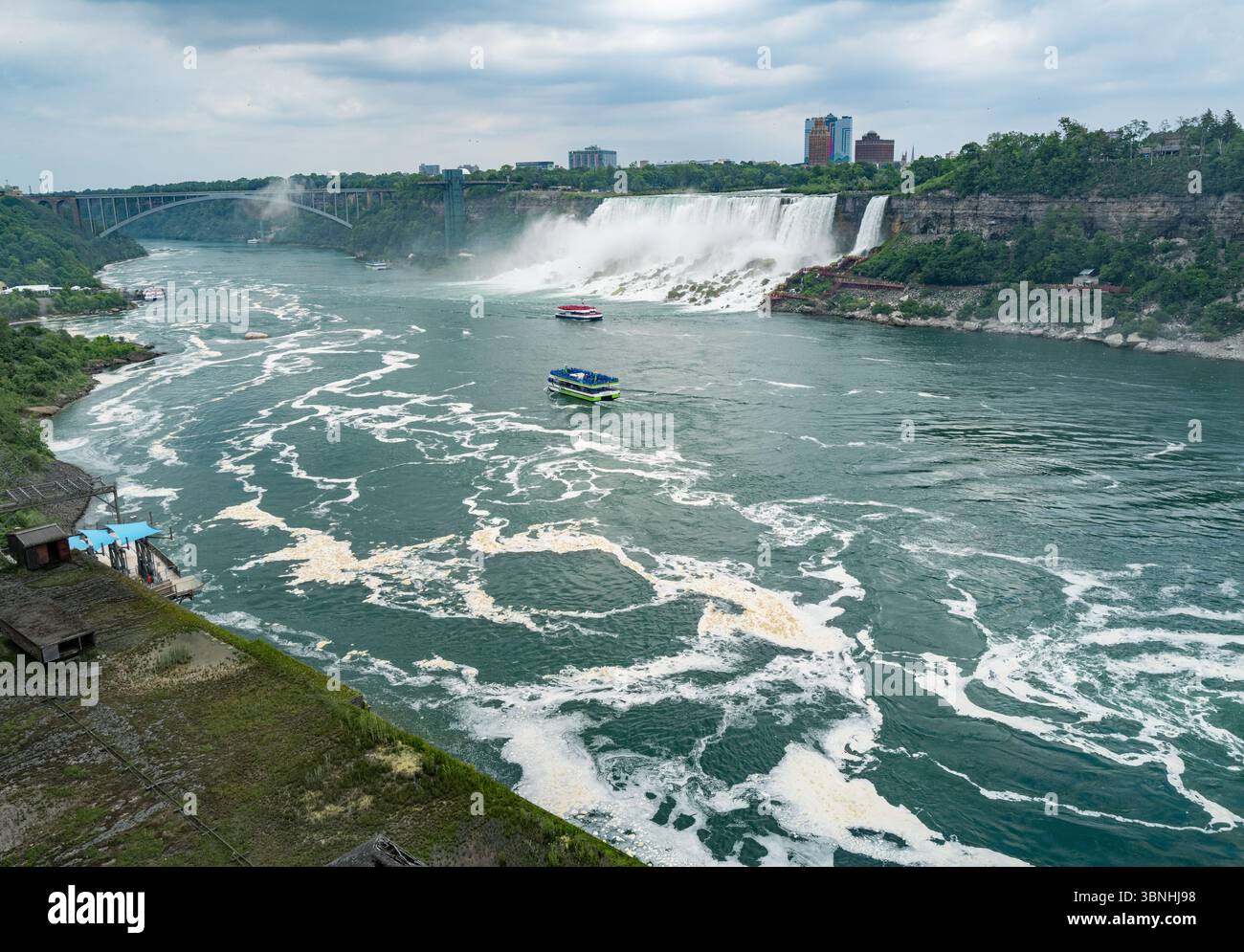 A red Niagara City Cruises boat and blue Maid of the Mist boat prepare ...