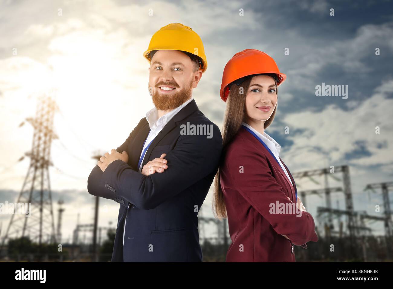 Power engineers in hard hats against electrical substation Stock Photo - Alamy
