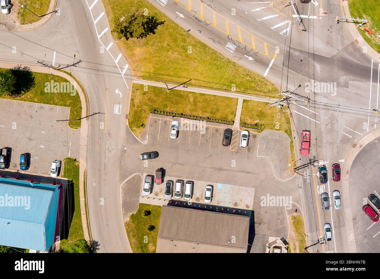 Overhead parking area with multiple vehicles, intersecting roads, green ...