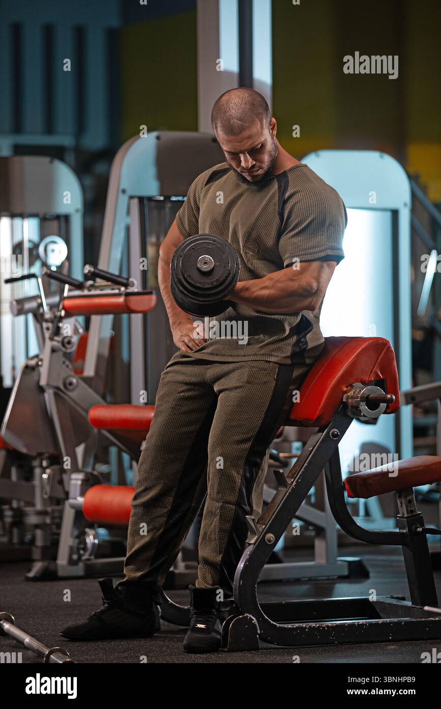 male athlete demonstrates strength and focus while performing bicep ...