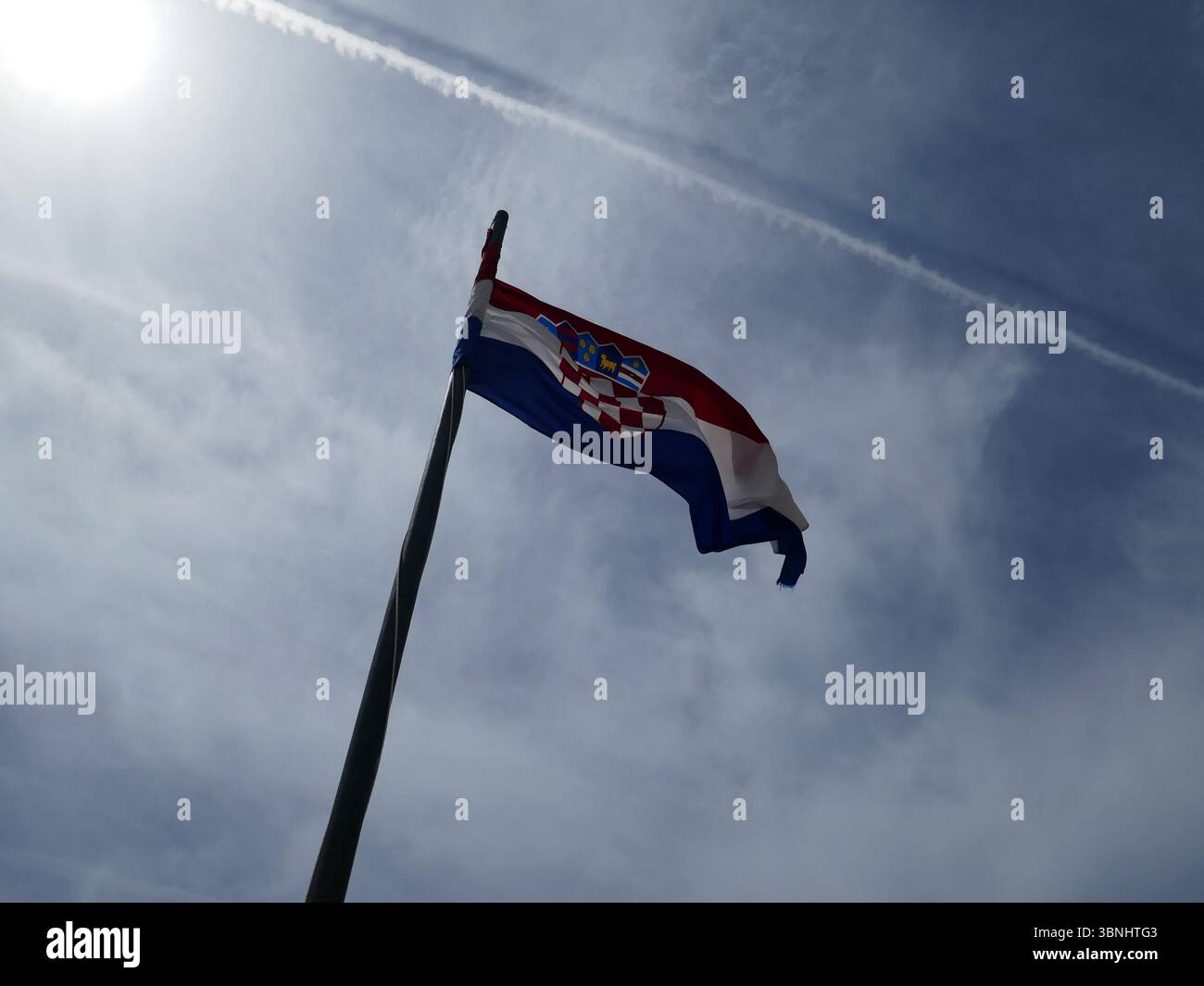 Croatian flag waving high in sky with jet airplane contrails Stock ...
