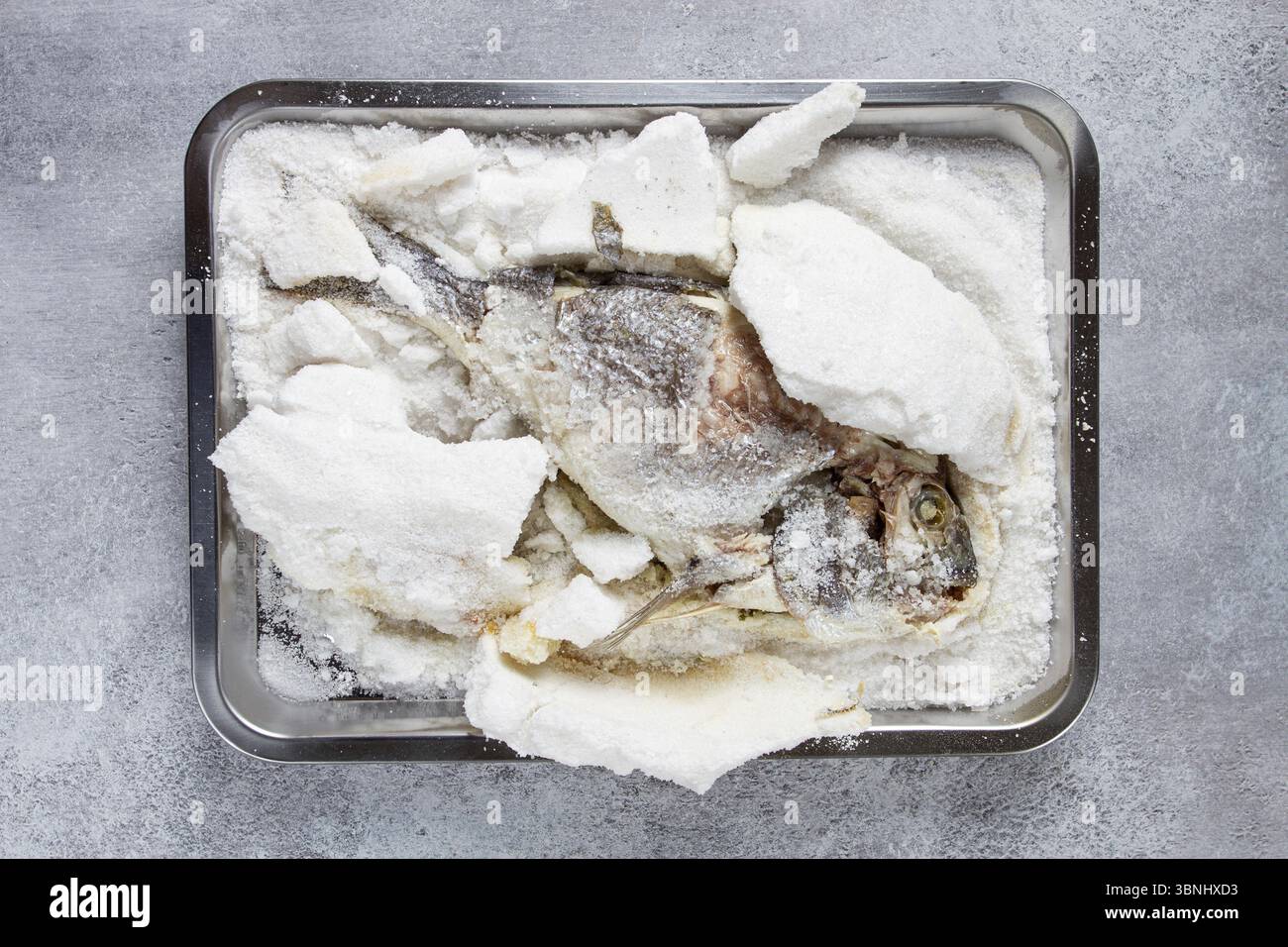 Baked Dorado fish, in salt on a baking sheet, top view, homemade, no ...