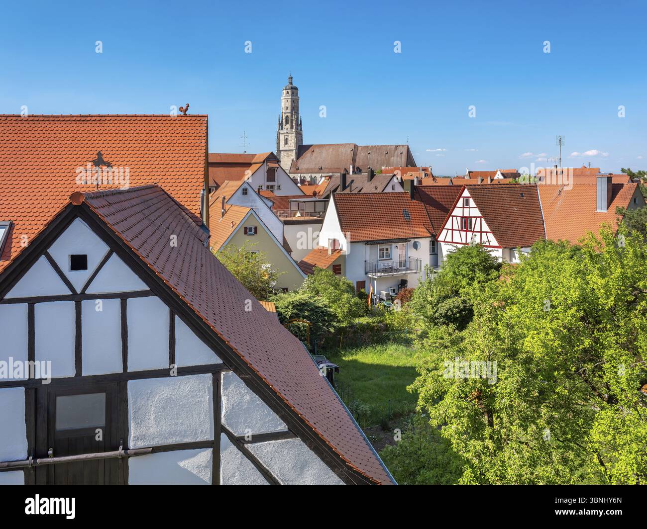View from the medieval town wall over the houses of the historic old town to the tower of St ...